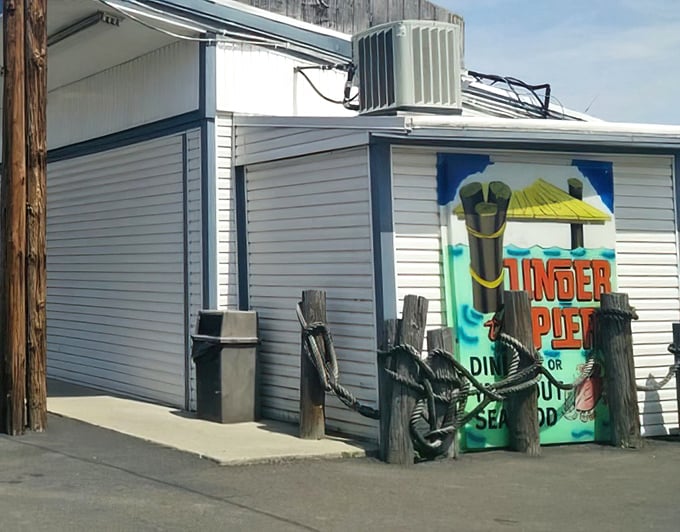 The unassuming exterior of Under the Pier looks like a movie set where seafood dreams and nautical nostalgia collide—complete with those charming porthole windows.