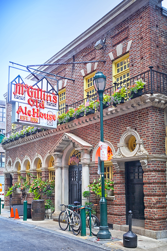 The patriotic facade of McGillin's Olde Ale House stands as Philadelphia's liquid history museum, where every brick has a story and every flag welcomes you home.