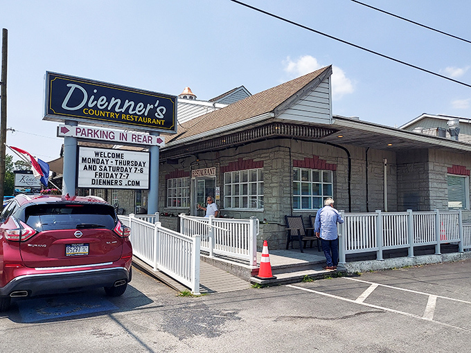 The unassuming exterior of Dienner's Country Restaurant beckons with its simple charm. Pennsylvania's best-kept secret hides behind that modest stone facade and white railing.