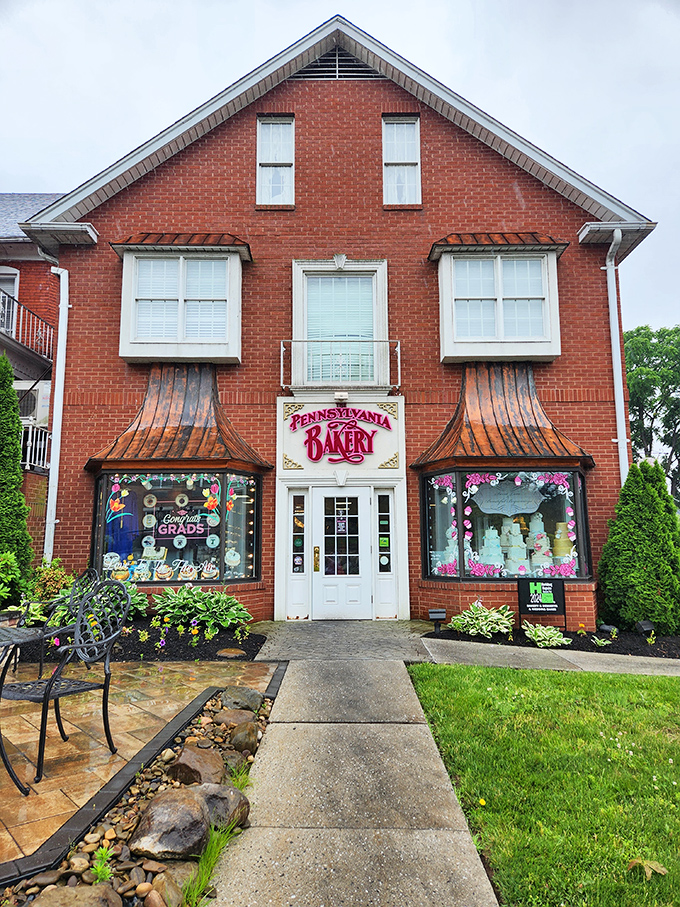The charming brick exterior of The Pennsylvania Bakery beckons with its distinctive copper awnings and colorful window displays—like a sweet-tooth siren call to dessert lovers.