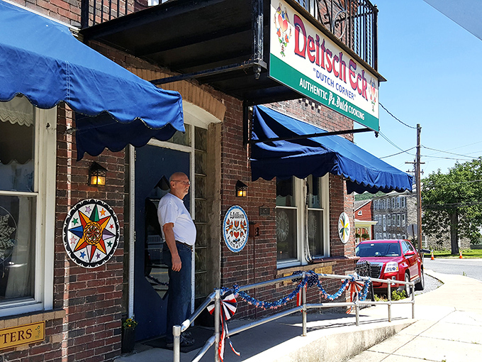 The brick facade of Deitsch Eck, with its vibrant blue awning and traditional hex signs, stands as a beacon of Pennsylvania Dutch authenticity in Lenhartsville.