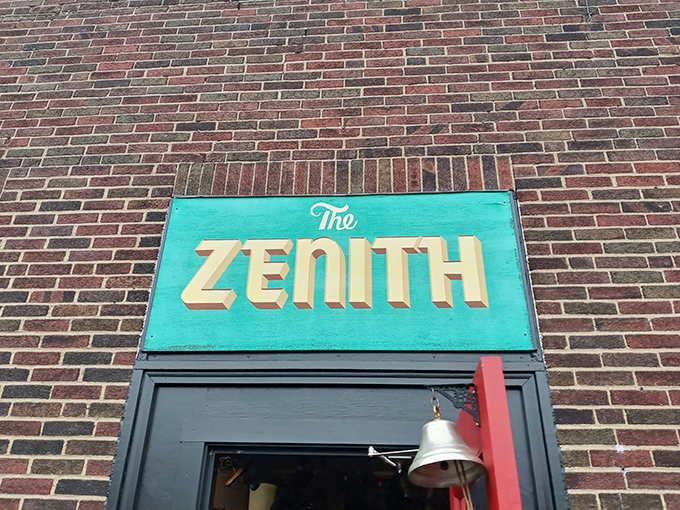 That turquoise sign against brick is like finding a peacock in a hen house—The Zenith announces itself with mid-century flair that promises something wonderfully different inside.