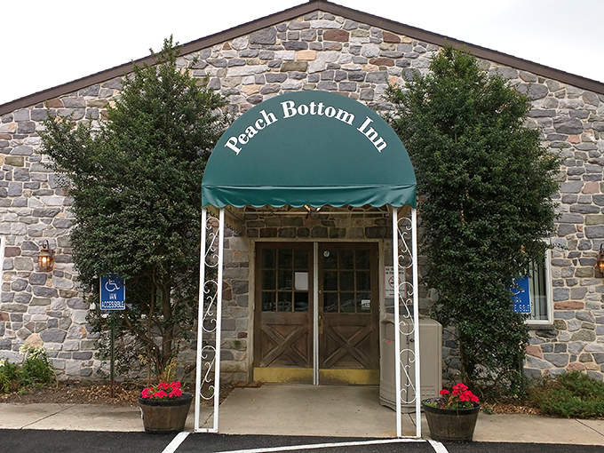 The stone facade and distinctive blue awning of Peach Bottom Inn isn't trying to be trendy—it's too busy being timeless.