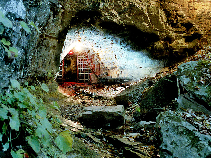 The entrance beckons with an eerie iron gate, like nature's own haunted doorway into Tennessee's most infamous supernatural hotspot.