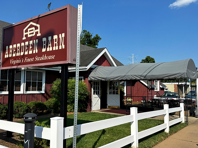 The barn-red exterior with white trim isn't just charming—it's a promise of the comfort food paradise waiting inside. String lights add a touch of magic to outdoor dining.