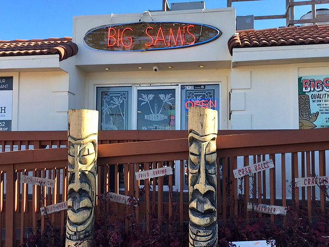 Those tiki guardians flanking Big Sam's entrance aren't just decoration—they're sentinels of seafood satisfaction standing watch over Virginia Beach's best-kept culinary secret.