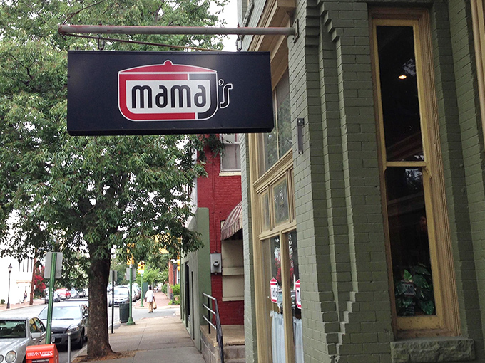 The unassuming green brick exterior of Mama J's belies the culinary treasures within—like finding a Michelin star restaurant disguised as your favorite aunt's house.