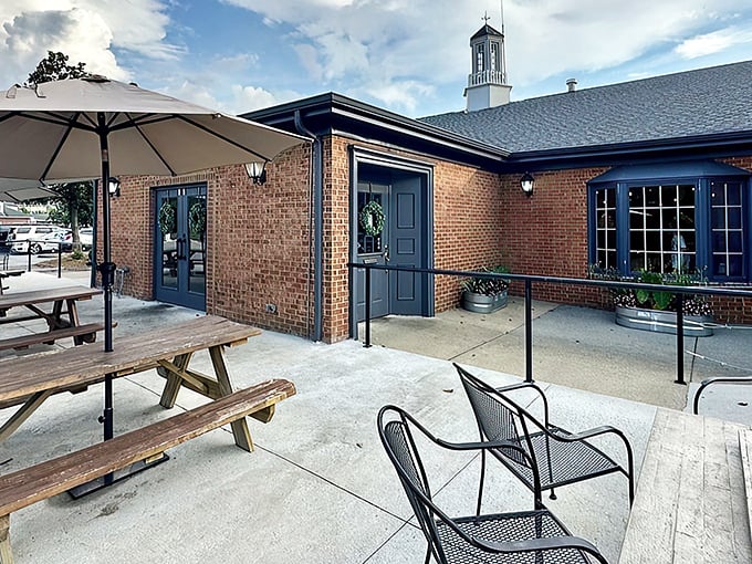 The brick exterior of Old City Barbeque offers a warm welcome, with picnic tables ready for those moments when the Virginia sky demands outdoor dining.