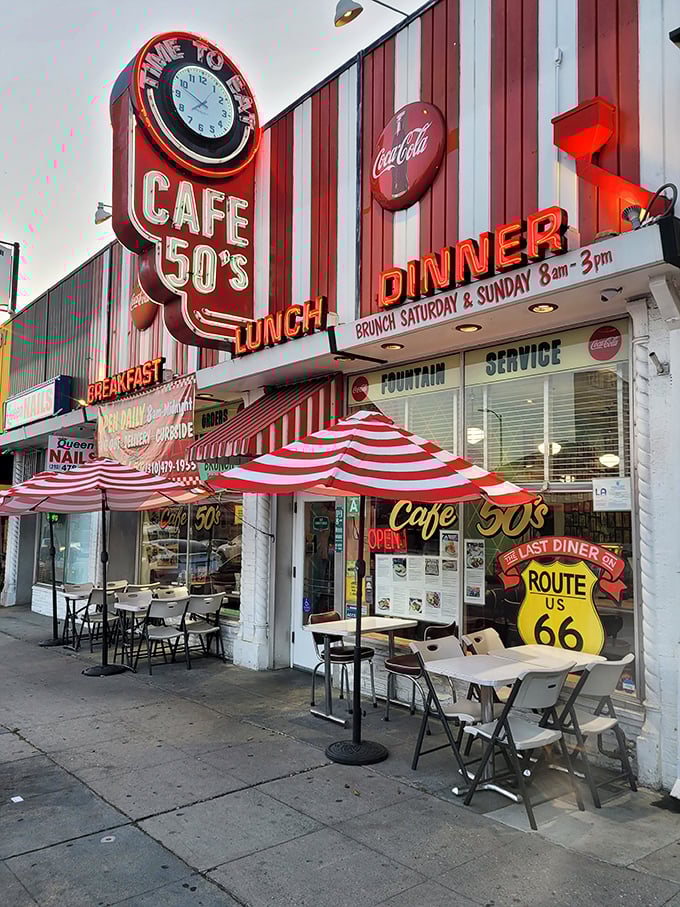 The red and white striped facade of Cafe 50's isn't just eye-catching—it's a time machine disguised as a diner on Santa Monica Boulevard.