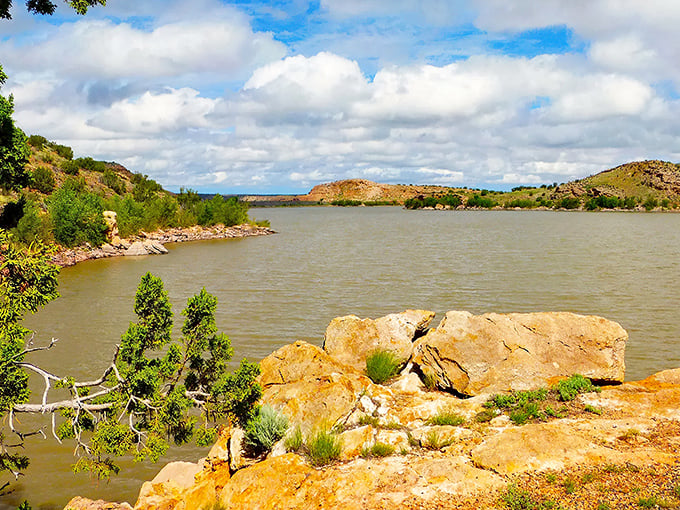 The serene waters of Lyman Lake stretch between colorful hills, offering a tranquil escape that feels like nature's version of a private resort.