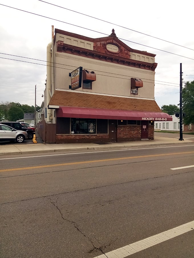 The iconic burgundy awning of Hickory Bar-B-Q stands as a beacon of smoky promise on this Dayton corner. Barbecue salvation awaits inside.