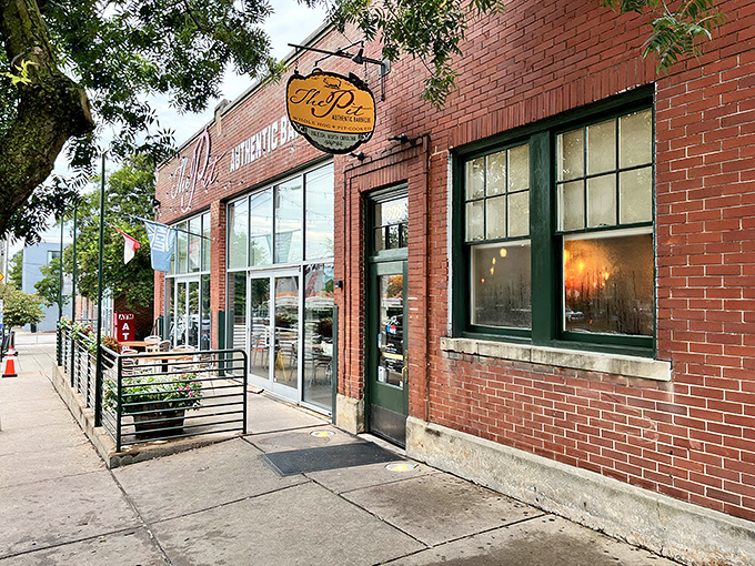 The brick exterior of The Pit beckons like a barbecue beacon in downtown Raleigh, promising smoky treasures within those unassuming walls.