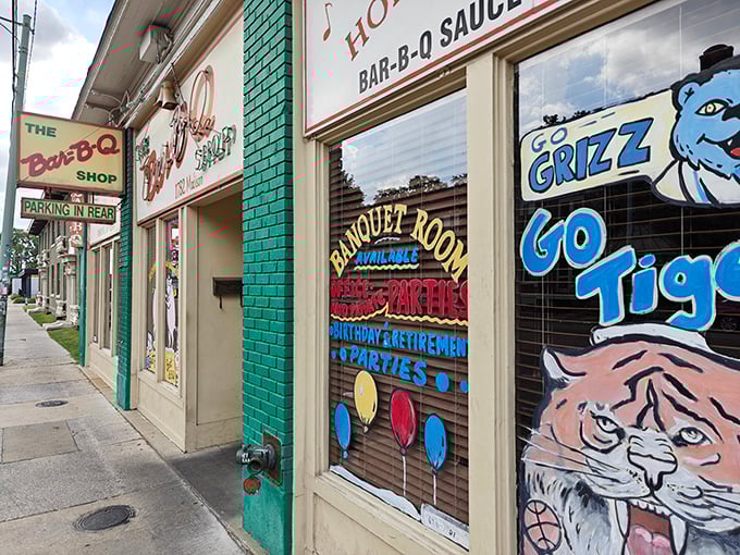 The iconic green storefront of The Bar-B-Q Shop proudly declares itself "Home of the Dancing Pigs," a promise of barbecue magic that awaits inside.