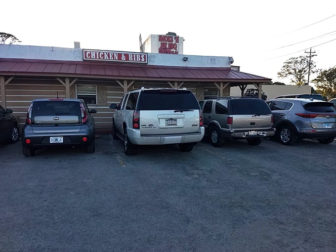 The unassuming wooden exterior of Smoke'n Pit screams "authentic barbecue inside!" Those rooftop signs aren't lying—this place means serious meat business.