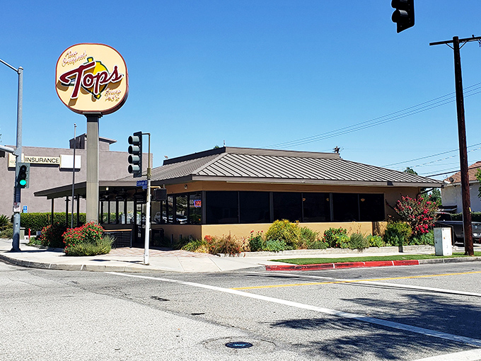 The iconic yellow sign beckons hungry Pasadenans like a burger lighthouse. Some landmarks guide ships; this one guides appetites.