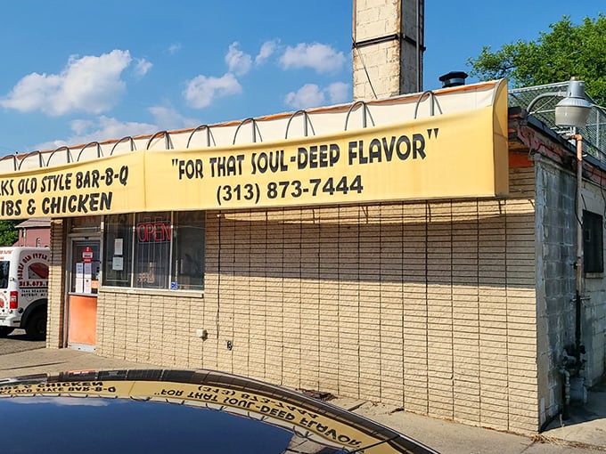The unassuming yellow facade promises "SOUL-DEEP FLAVOR" – a rare case of truth in advertising that Detroit BBQ aficionados have known for years.