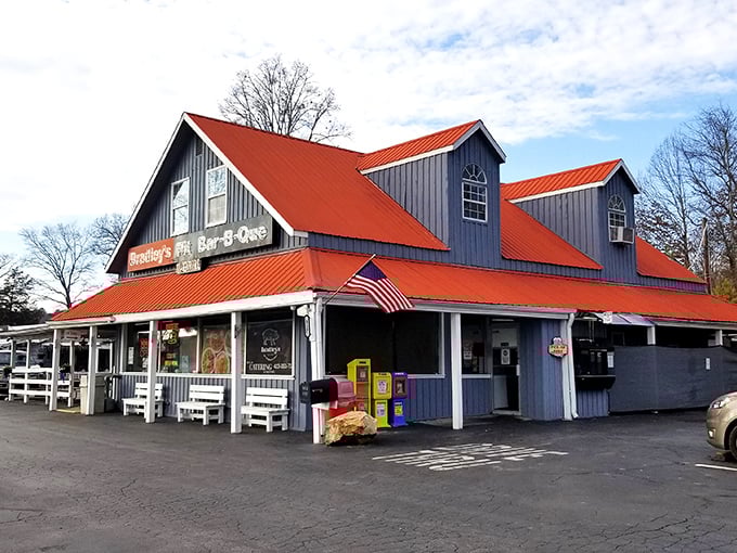 The blue building with its bright orange roof stands like a beacon of barbecue hope on the Tennessee horizon. White benches await the inevitable line of hungry patrons.