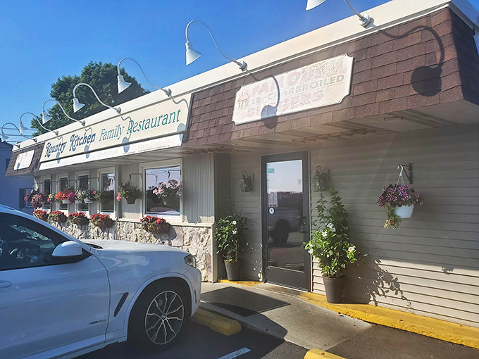 The unassuming exterior of Kountry Kitchen, where hanging flower baskets offer the first hint that someone inside really cares about the details.