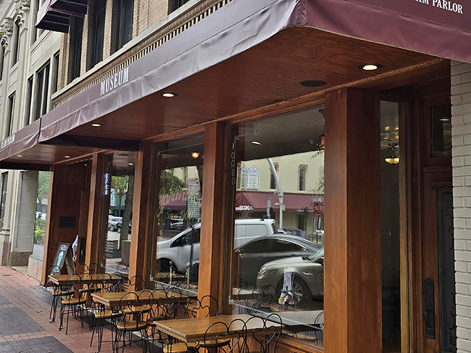 The entrance to Zaharakos beckons like a portal to another era, with stained glass windows and wooden doors that have welcomed ice cream lovers since 1900.