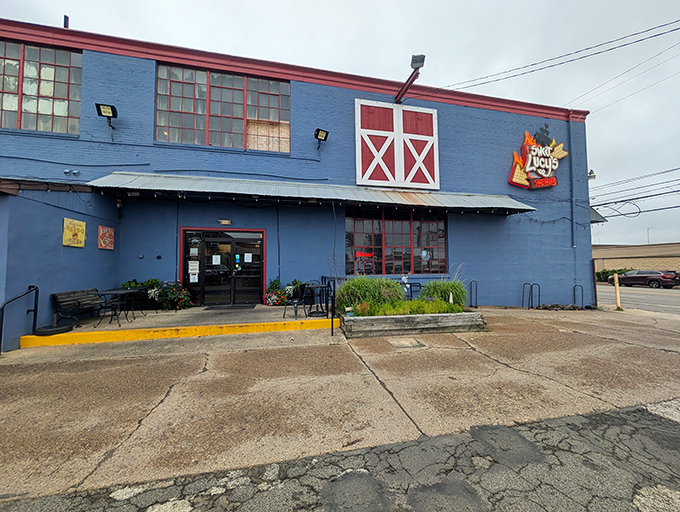 The blue barn-like exterior of Sweet Lucy's stands as a beacon of barbecue hope in Northeast Philly—architectural proof that great BBQ needs no fancy facade.