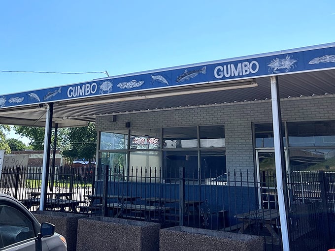 The blue awning with "GUMBO" repeated like a delicious mantra tells you everything you need to know about this Dallas treasure.