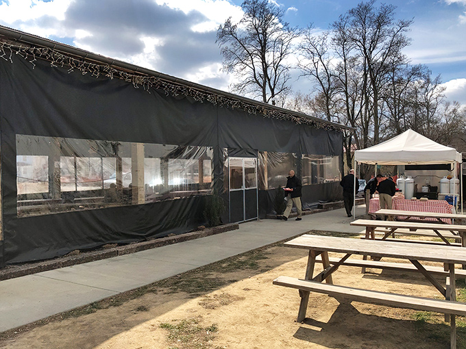 The covered patio at Eli's BBQ is where summer memories are made, with wildflowers nodding hello as smoke wafts through the air.