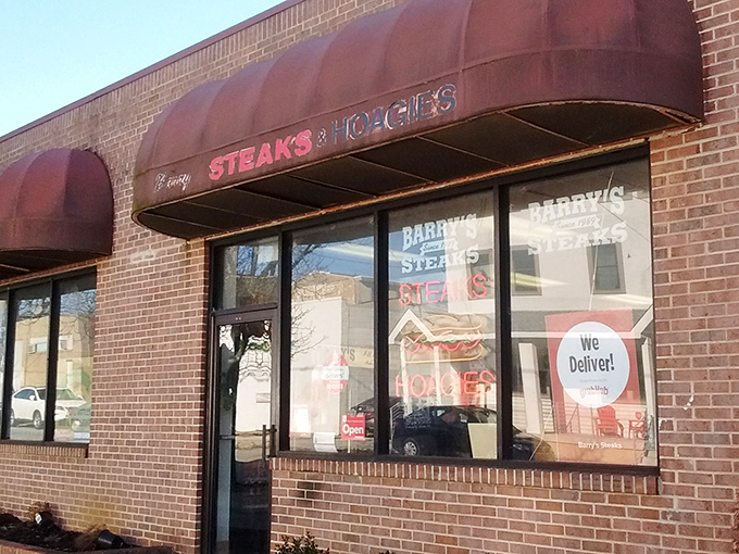 The unassuming brick storefront with burgundy awnings might not scream "food paradise," but locals know this is where cheesesteak dreams come true.