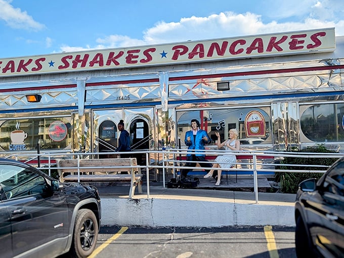 The gleaming silver exterior of All American Diner shines like a beacon of breakfast hope on Panama City Beach, promising "STEAKS * SHAKES * PANCAKES" in bold red letters.