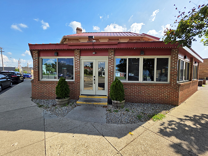 The brick exterior of Old Canal Smoke House beckons like a BBQ lighthouse on Chillicothe's horizon. Those twin evergreens aren't just decorative—they're standing guard over smoky treasures within.