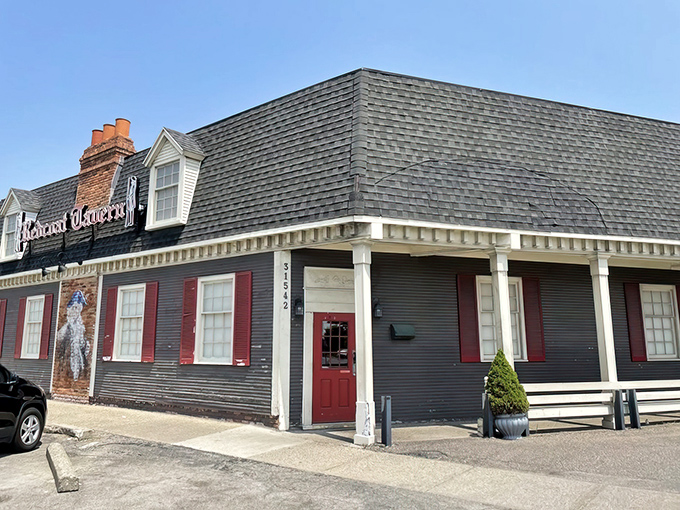 Colonial charm meets Midwest hospitality at Redcoat Tavern's distinctive exterior. That red door isn't just an entrance—it's a portal to culinary bliss. 