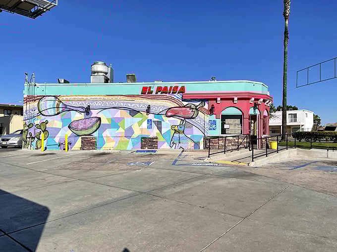 The coral-colored exterior of Tacos El Paisa glows like a beacon in the night, promising authentic Mexican flavors to all who approach.