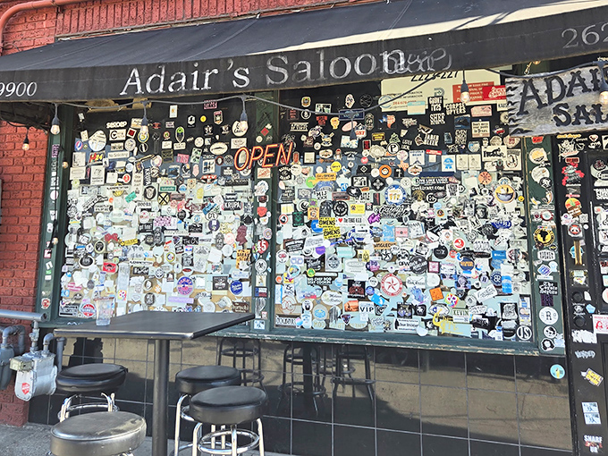 The sticker-plastered facade of Adair's Saloon isn't just a door to a bar—it's a portal to authentic Dallas honky-tonk heaven.
