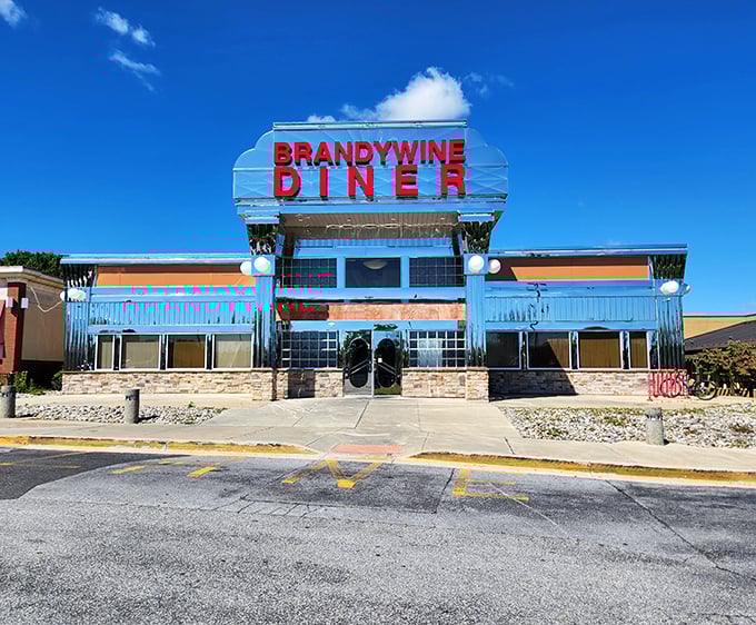 That gleaming chrome exterior isn't just architecture—it's a promise of comfort food nirvana waiting inside. The Brandywine Diner stands proud against the Delaware sky.