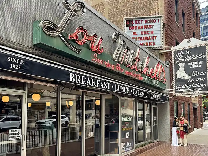 The neon sign at Lou Mitchell's doesn't just glow—it beckons like an old friend promising comfort in the form of perfectly scrambled eggs and bottomless coffee.