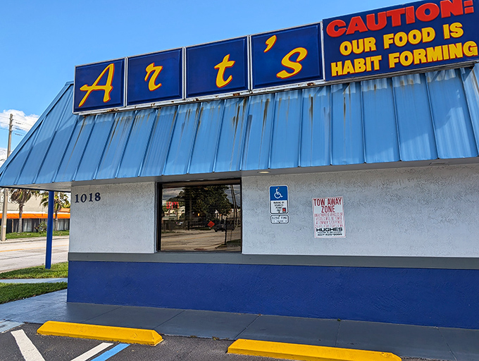 The iconic blue-roofed Art's beckons hungry travelers with its warning sign: "Caution: Our Food is Habit Forming." Truer words were never illuminated.