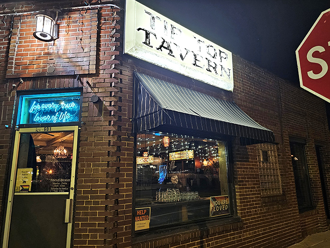The neon sign promising "forever true, lover of life" isn't lying – Tip Top Tavern's modest brick exterior hides Madison's most authentic neighborhood gathering spot.