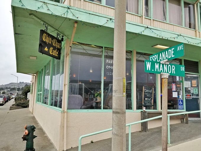 The mint-green facade of Chit Chat Cafe stands like a humble sentinel at the edge of the Pacific, promising simple pleasures and million-dollar views.