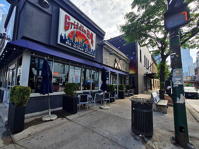 The navy blue awnings of Griddle 24 stand out on Chicago Avenue like a breakfast beacon, promising urban diner delights inside.