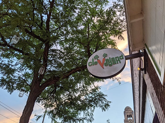 The Cleveland Vegan sign peeks out from beneath leafy branches, like nature giving its stamp of approval to this plant-based haven in Lakewood.