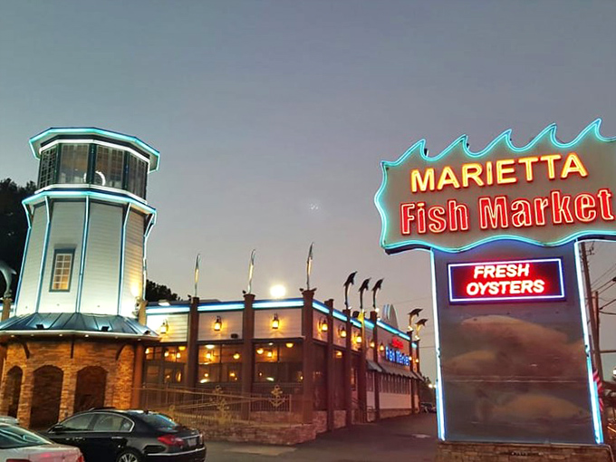 The lighthouse-topped exterior of Marietta Fish Market stands like a coastal beacon in suburban Atlanta, promising seafood treasures within.