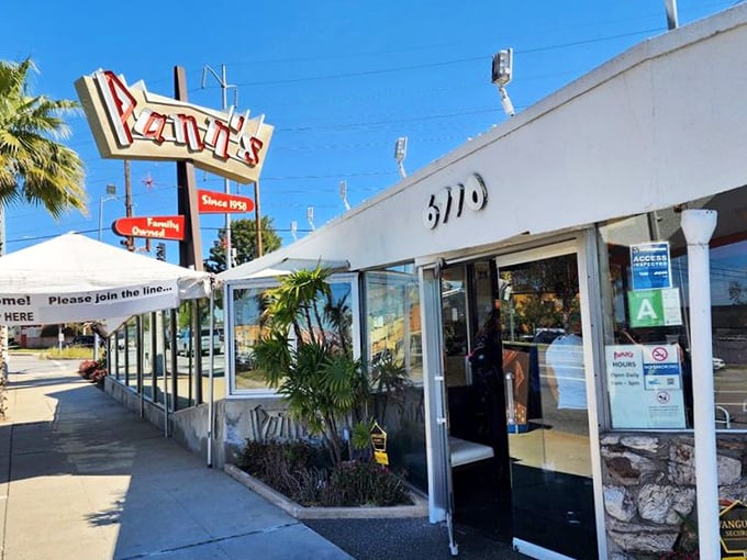 That iconic neon sign isn't just calling you to breakfast—it's beckoning you back to an era when diners were social hubs and architectural statements rolled into one delicious package.