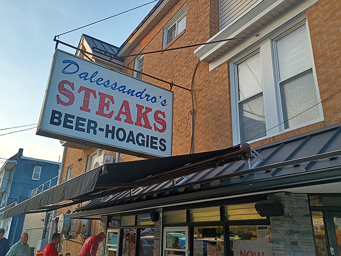 The iconic blue and red sign beckons hungry pilgrims like a sandwich lighthouse. No fancy frills, just the promise of Philadelphia's finest between bread.
