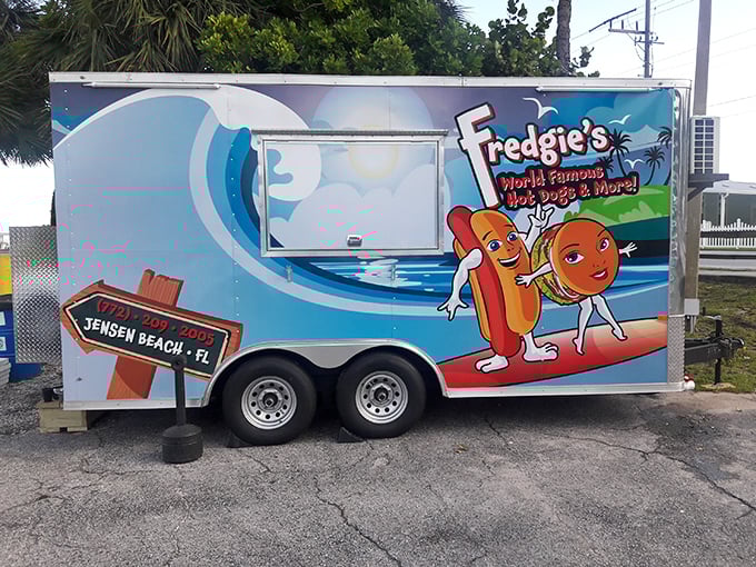 That cheerful blue food truck isn't just transportation – it's a mobile temple of hot dog happiness.