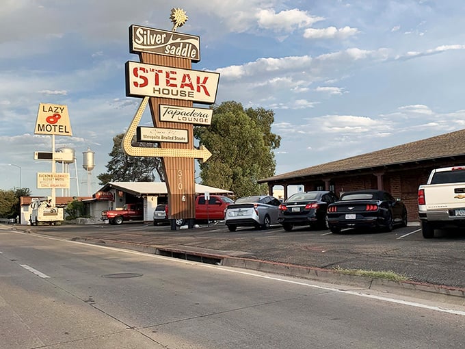 That vintage sign isn't just advertising – it's a time machine to when steakhouses were landmarks, not afterthoughts. The Silver Saddle stands proud against the Arizona sky.