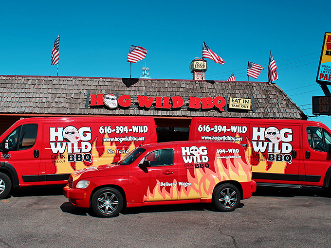 The log cabin exterior of Hog Wild BBQ stands like a beacon of smoky promise along Holland's roadside, calling to barbecue pilgrims far and wide.