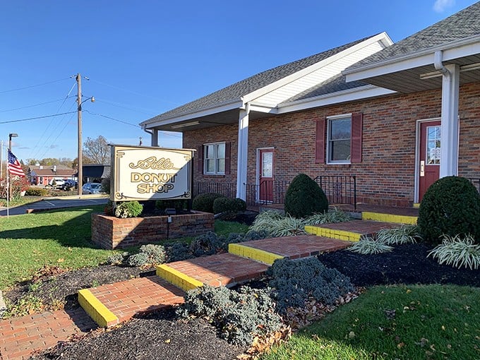 The unassuming brick exterior of Bill's Donut Shop stands like a temple to fried dough, complete with American flag – patriotism never tasted so sweet.