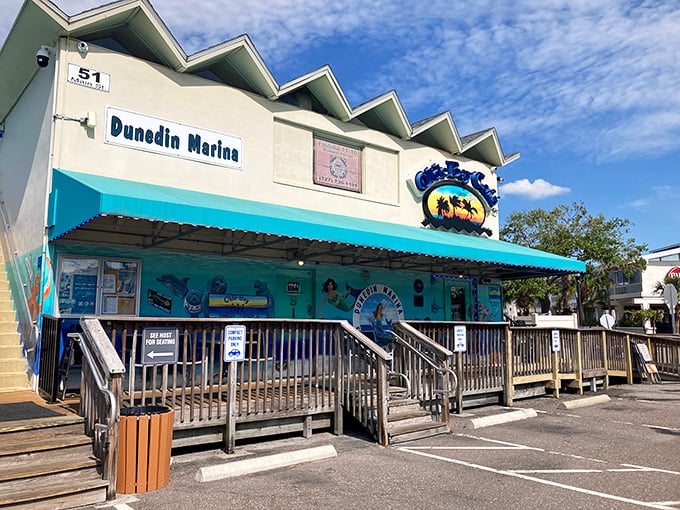 The turquoise facade of Olde Bay Cafe stands out against Florida's sky like a cheerful invitation to seafood paradise. No pretension, just promise.