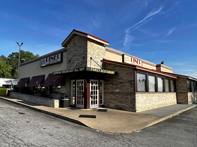 The stone facade of Sandy Springs Diner stands like a culinary fortress, promising comfort food treasures within those burgundy-awninged walls.