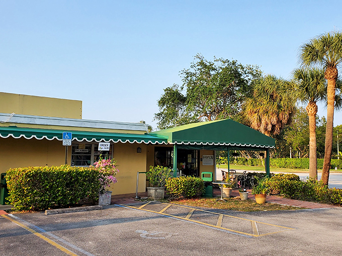 The unassuming yellow building with its green awning and sign might not look like a culinary destination, but locals know better—sandwich paradise awaits inside.
