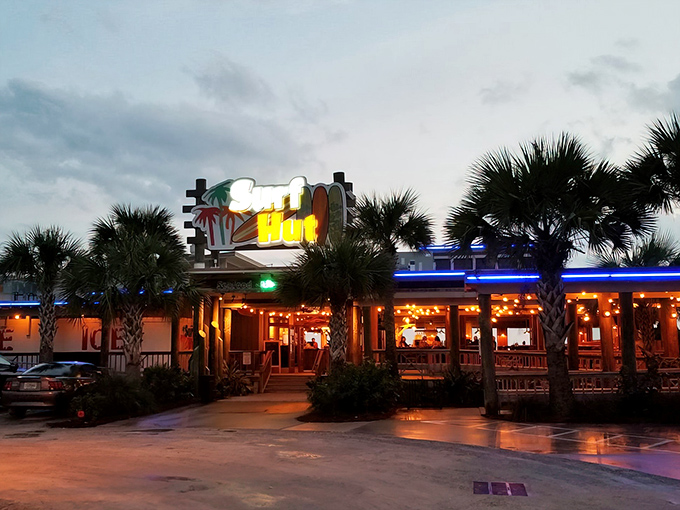 The entrance to paradise doesn't require pearly gates—just palm trees, a colorful sign, and the promise of seafood that'll make you weep with joy.